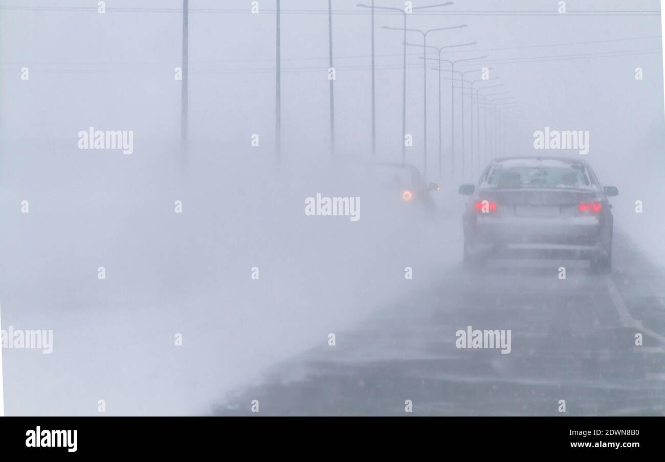 Snow storm on the road. Very difficult weather conditions. Zero ...
