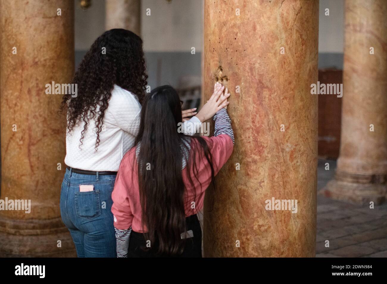 23 December 2020, Palestinian Territories, Bethlehem: People touch the ...