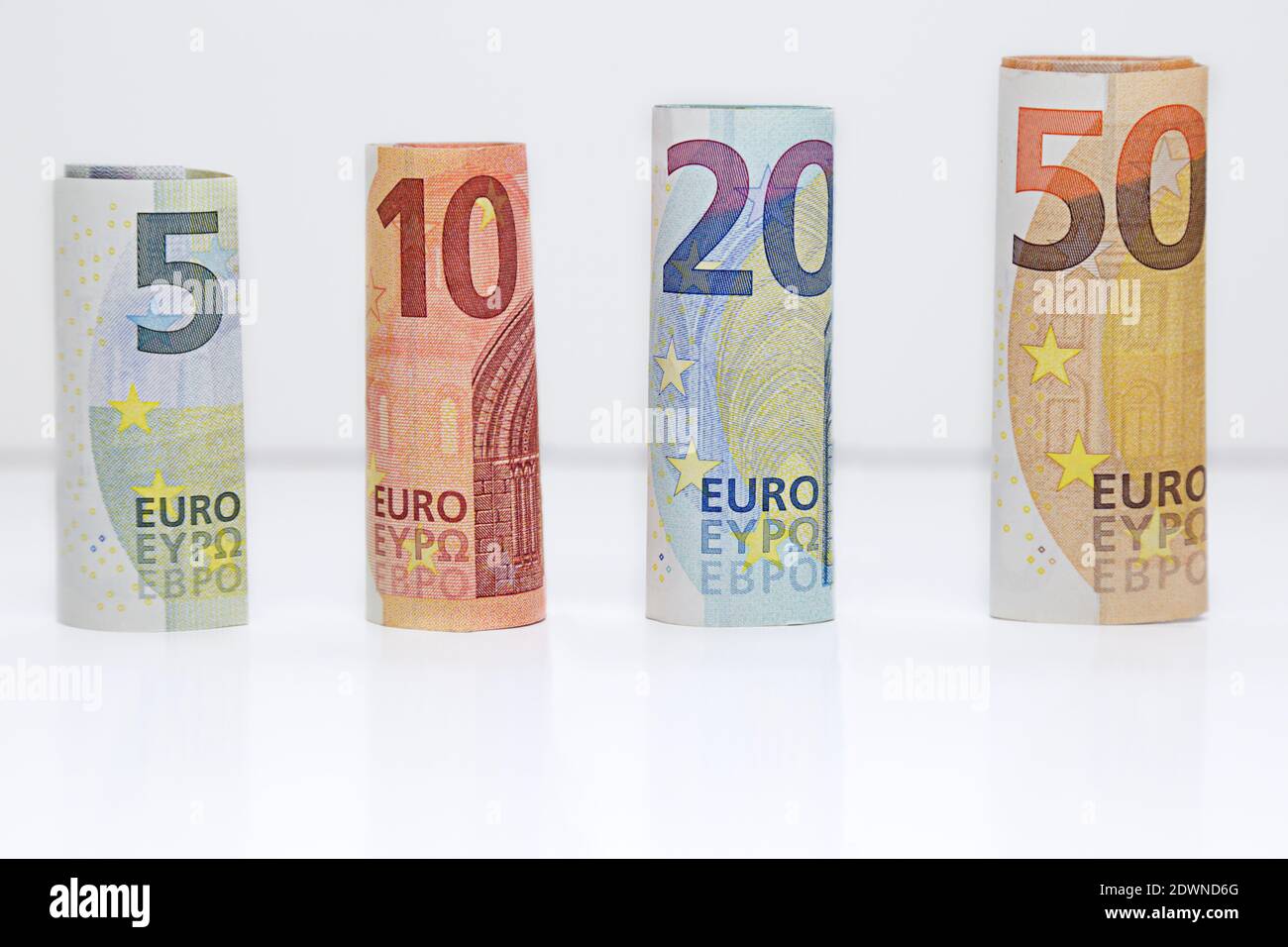 Rolled up Euro bills on white background Stock Photo - Alamy