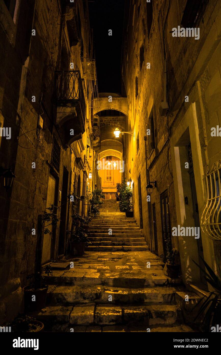 Empty Alley Amidst Buildings In City At Night Stock Photo - Alamy