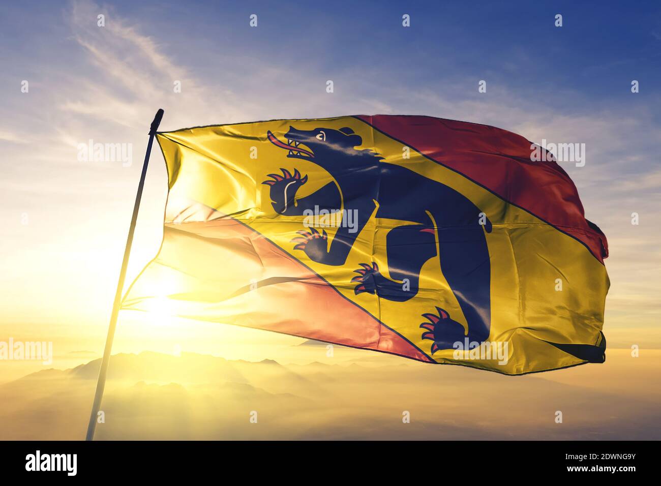 Bern canton of Switzerland flag waving on the top sunrise mist fog ...