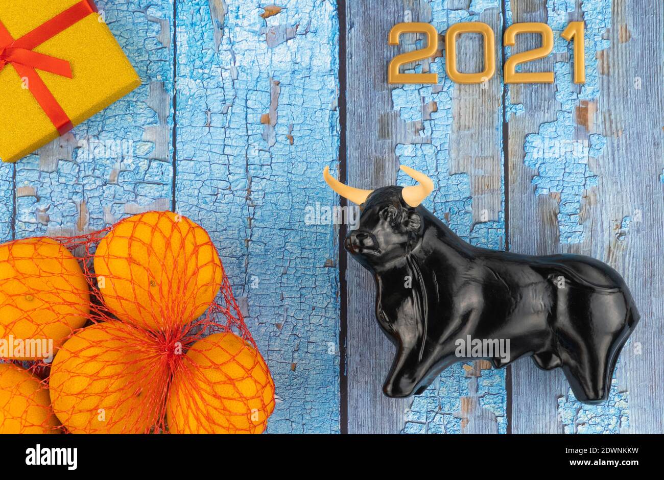 Christmas bull and numbers 2021 on a wooden background. ox, a symbol of ...