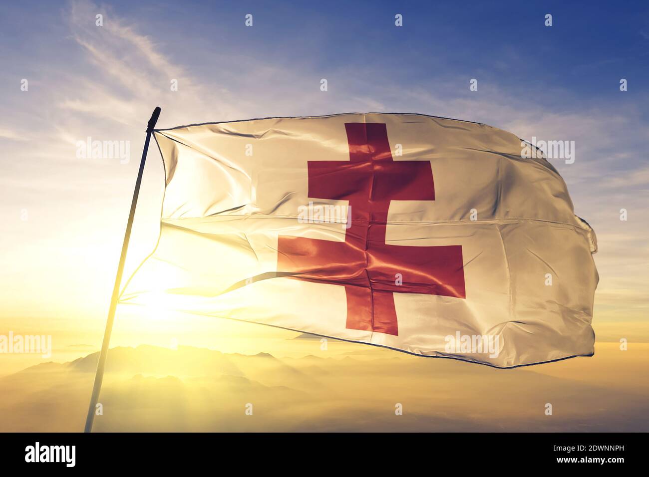 Ypres of West Flanders of Belgium flag waving on the top sunrise mist ...
