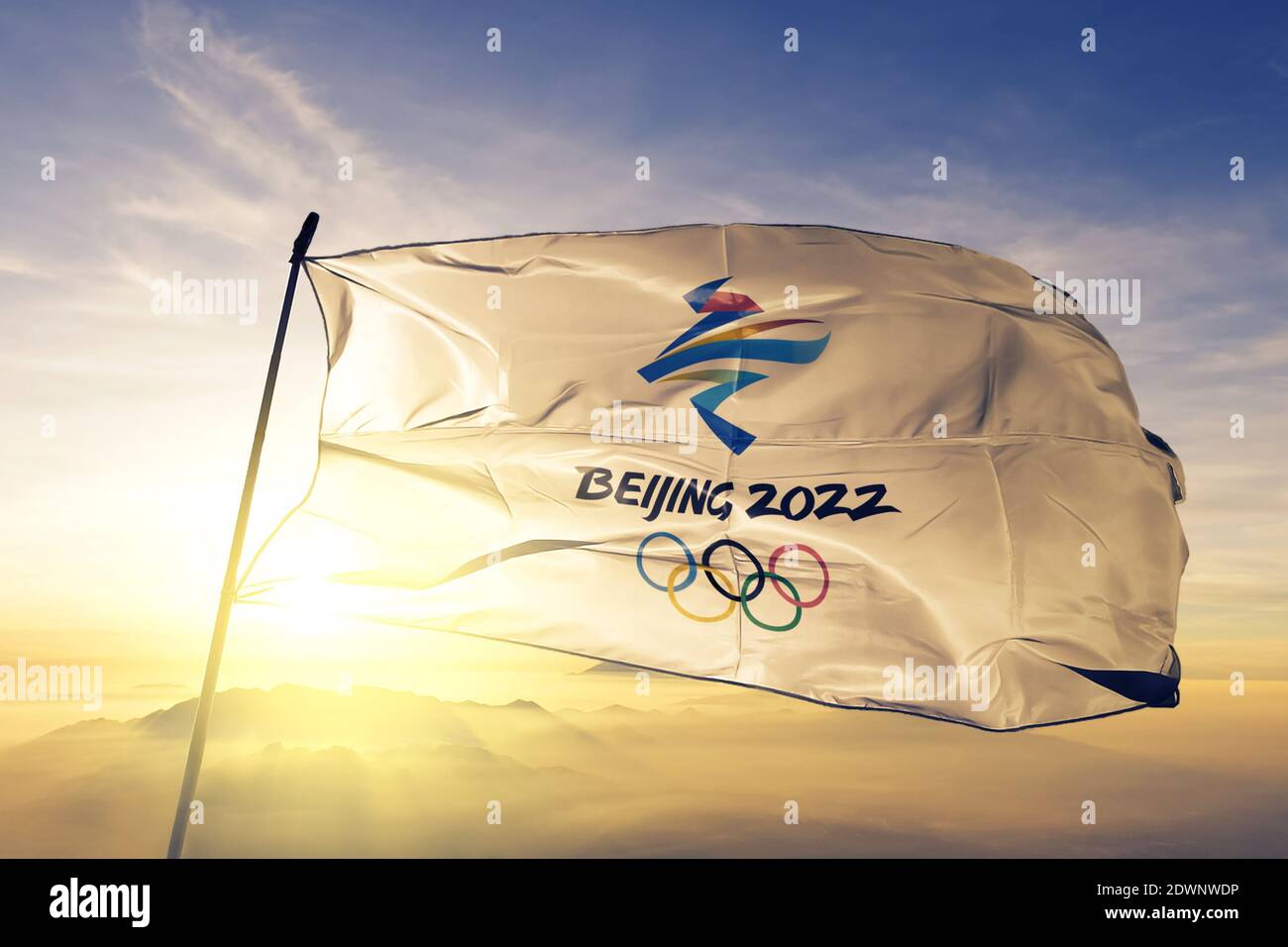 2022 Winter Olympics logo flag waving on the top sunrise mist fog Stock ...