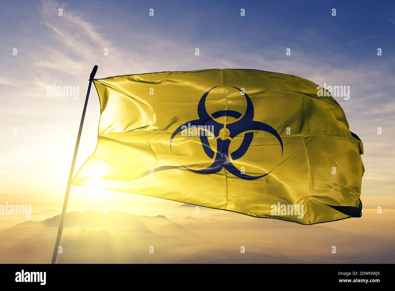Biohazard flag waving on the top sunrise mist fog Stock Photo - Alamy