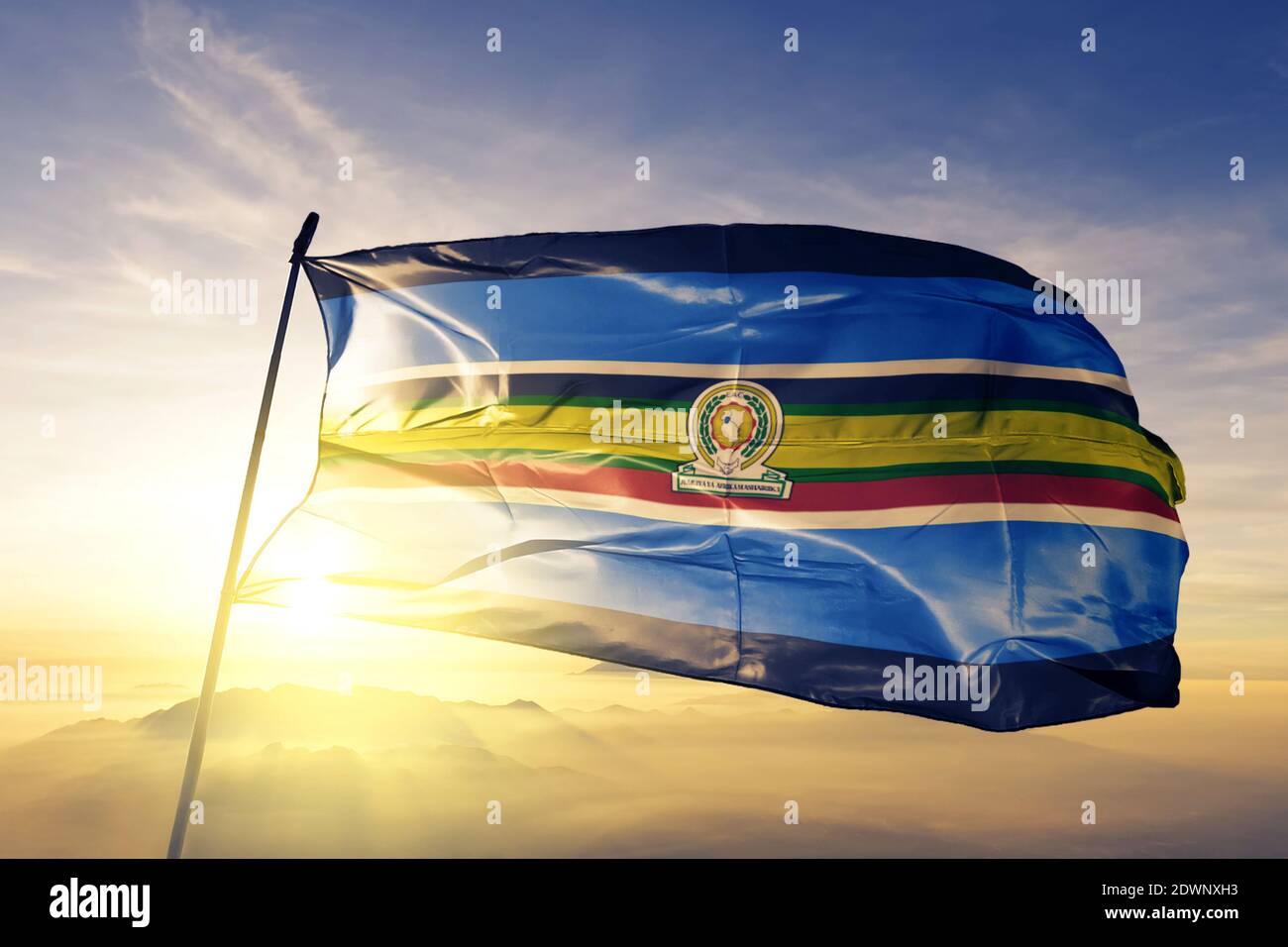 East Africa Community EAC flag waving on the top sunrise mist fog Stock ...