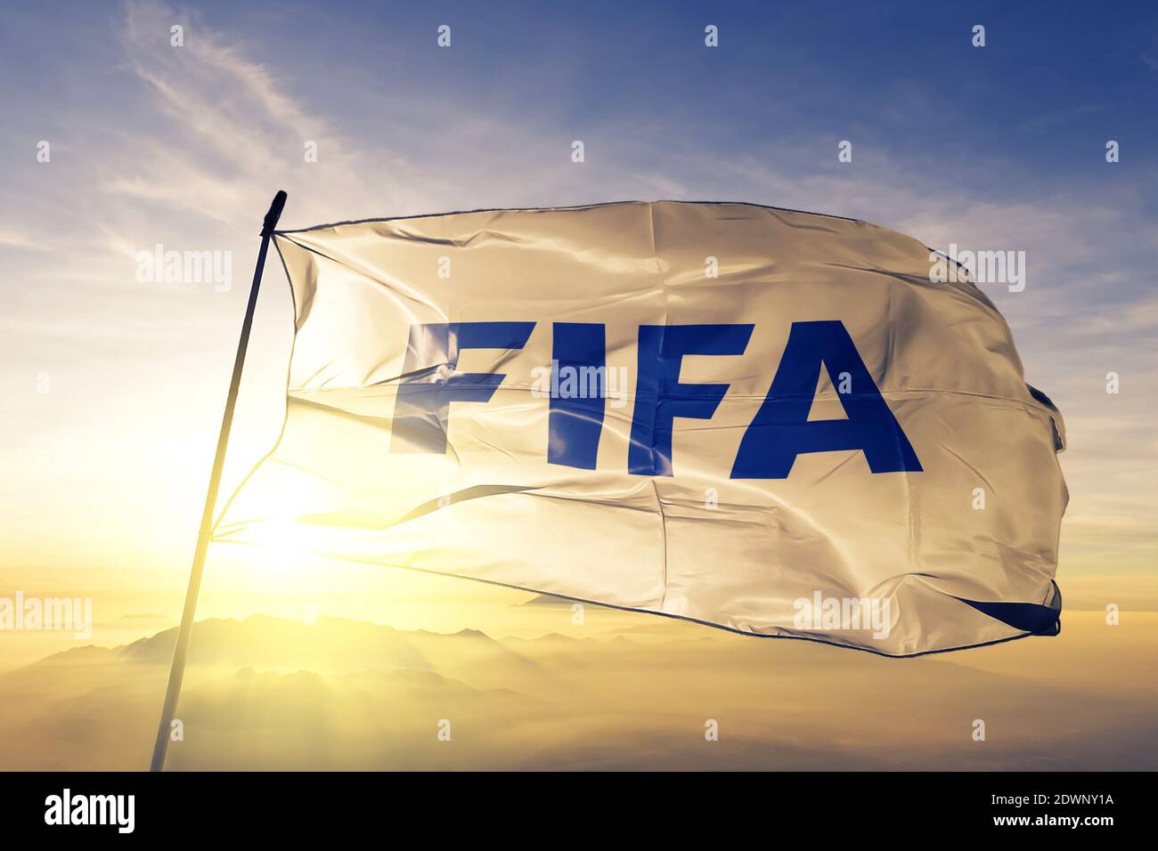 FIFA logo flag waving on the top sunrise mist fog Stock Photo - Alamy