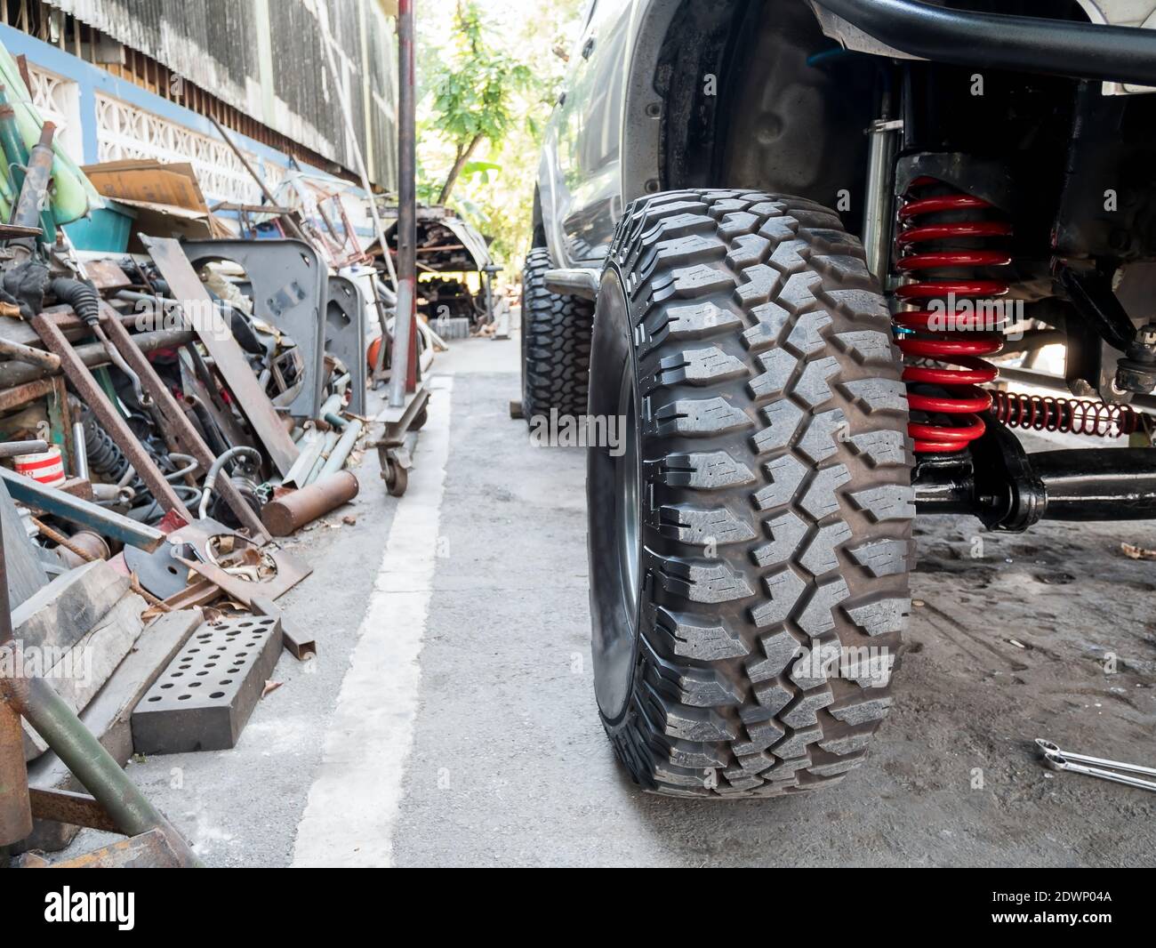 Closeup front wheel and suspension of the four-wheel drive pickup truck ...