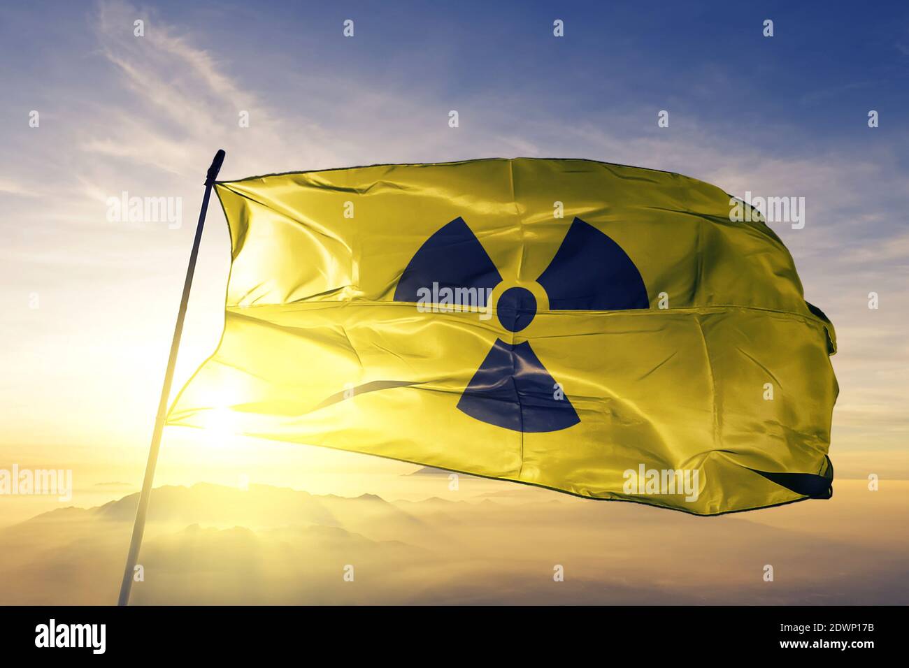 Radioactive flag waving on the top sunrise mist fog Stock Photo - Alamy