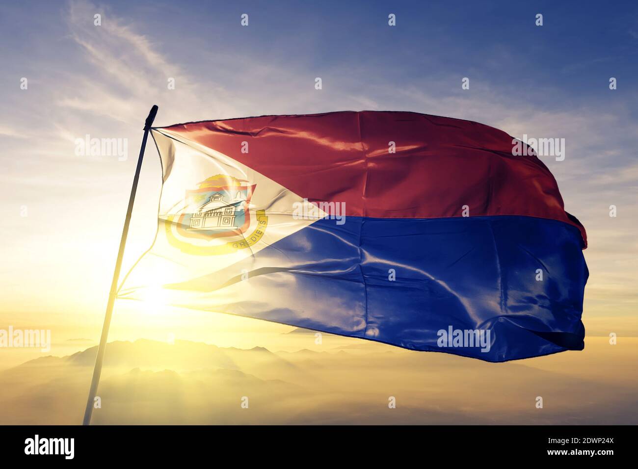 Sint Maarten flag waving on the top sunrise mist fog Stock Photo - Alamy