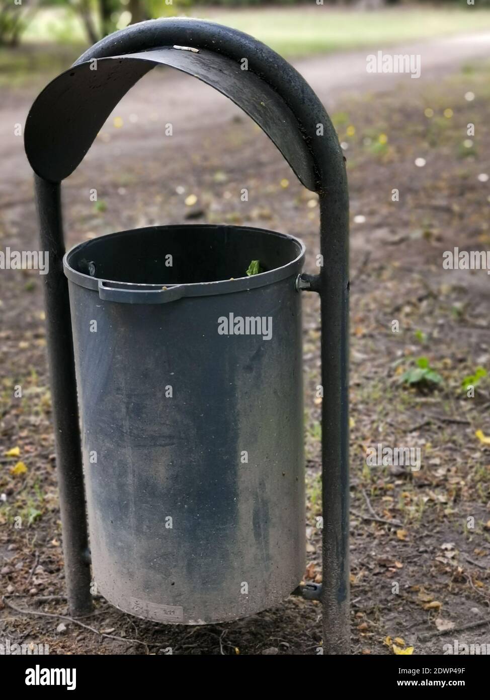 A vertical closeup shot of an empty public trash can in a park Stock ...