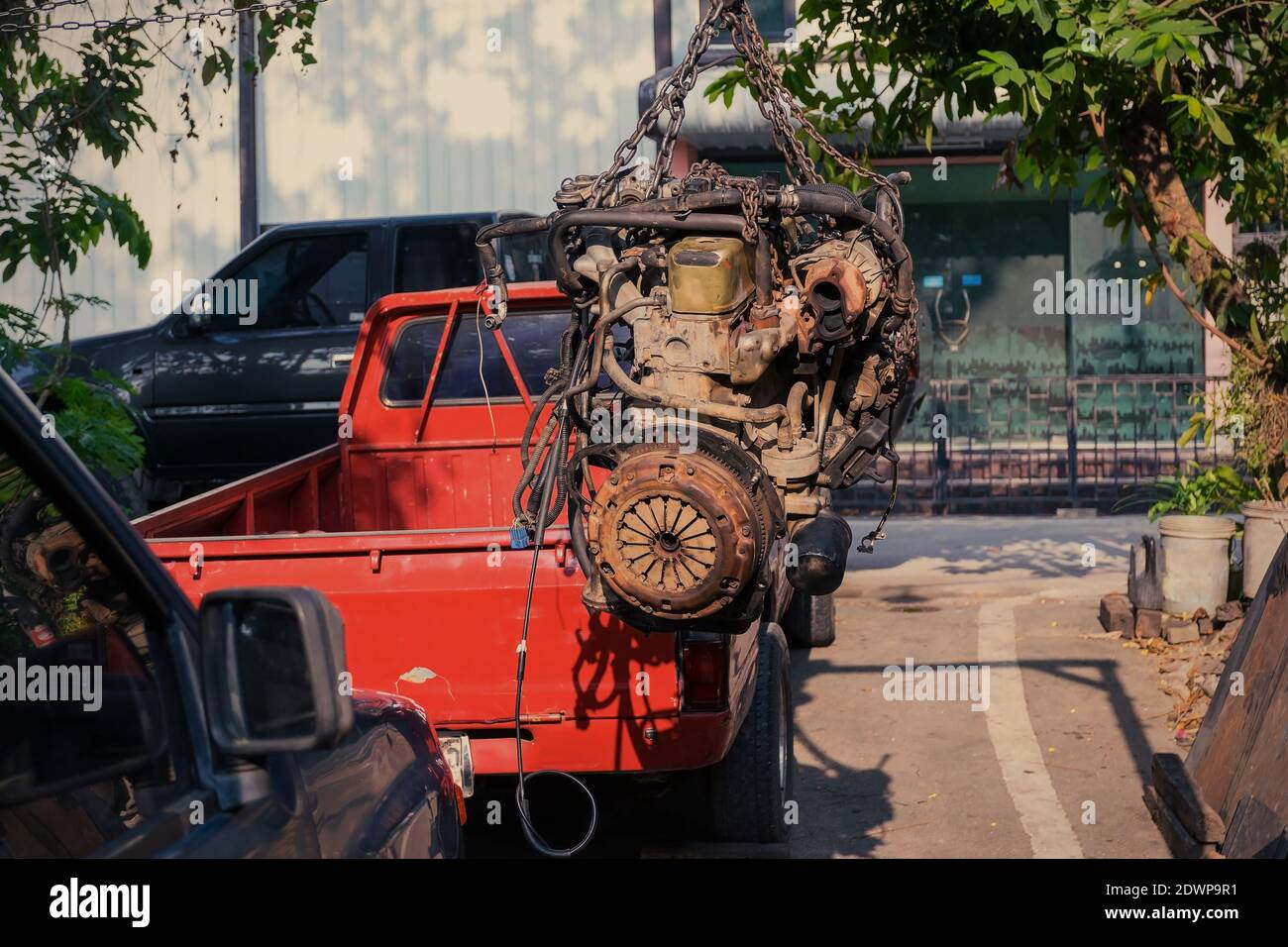 Old or used car engine hanging on the crane in the garage, Automotive ...