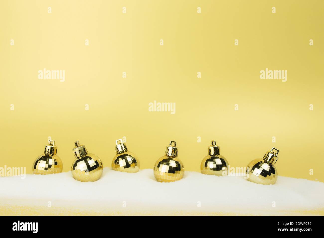 Gold christmas tree balls on gold background with fake snow Stock Photo ...