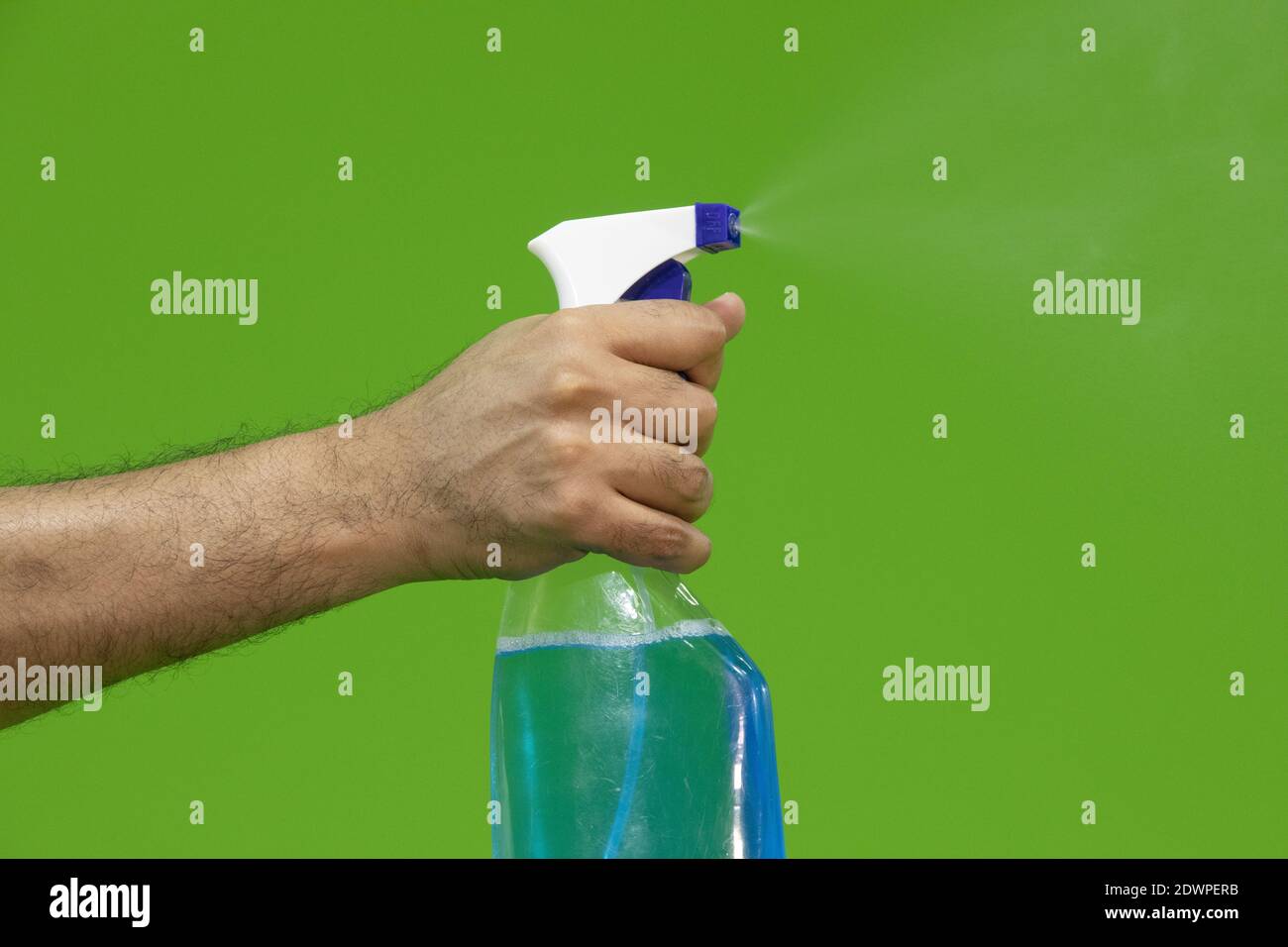 cleaning a window with cleaning sprayer Stock Photo - Alamy