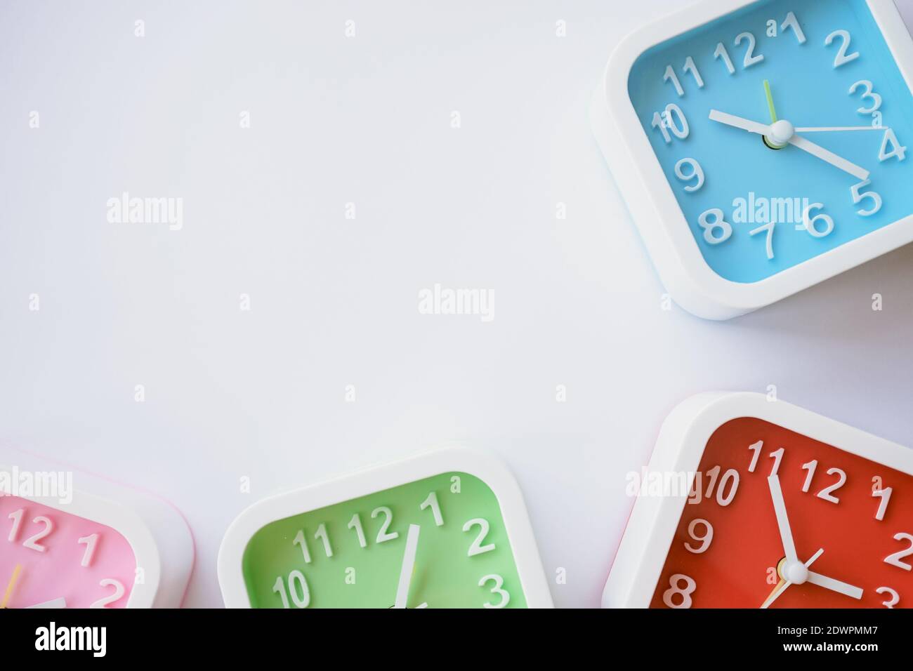 Colorful Clocks On White Background Stock Photo - Alamy