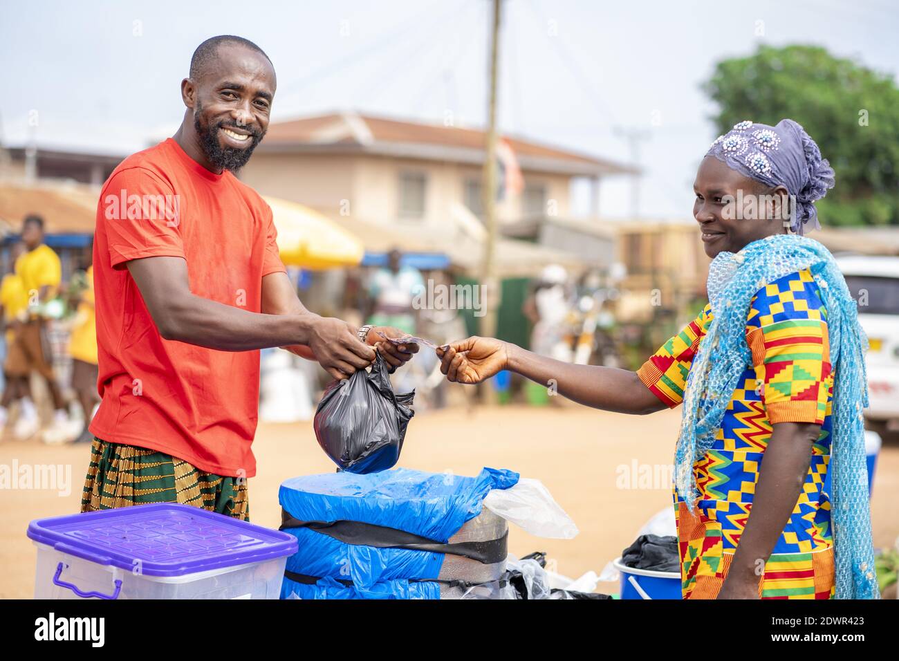 An African woman making a purchase in a street market in Ghana Stock ...