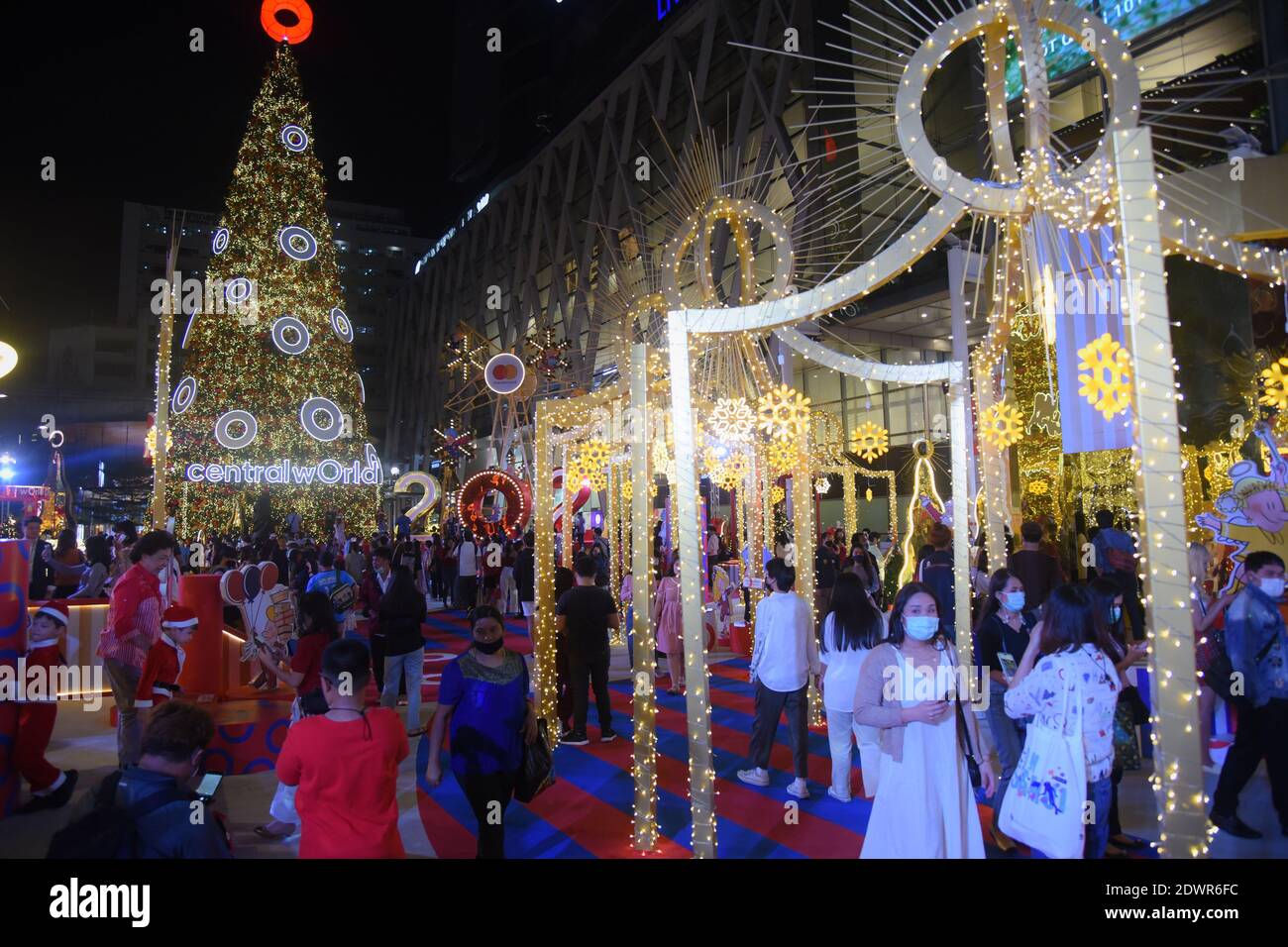 People seen at a shopping mall set up with Christmas lights and ...