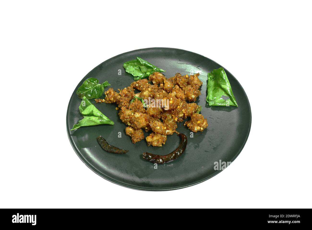 spicy fried chicken tendon with chili and lemon leaf on dish Stock ...