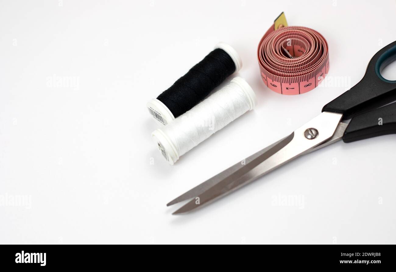 Scissors, tape measure and threads on a white background. Sewing kit ...