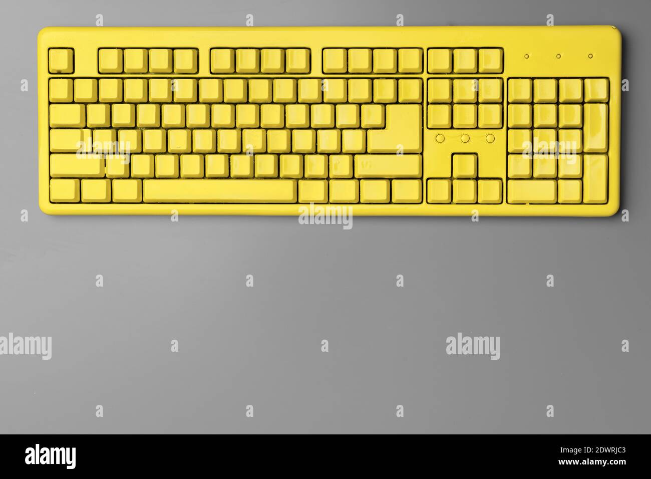 Yellow computer keyboard on gray background top view Stock Photo - Alamy