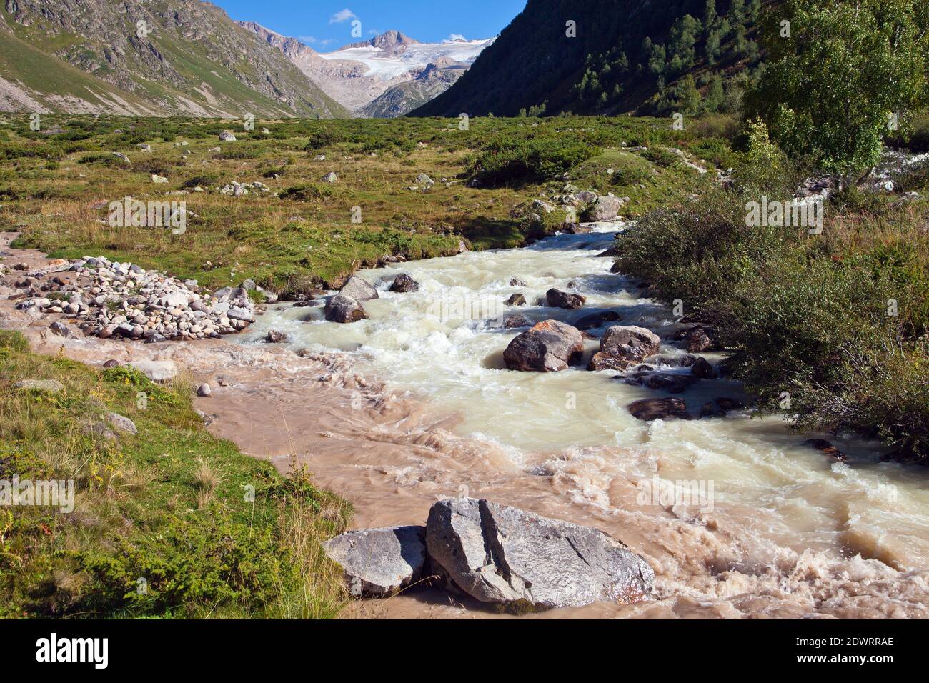 The confluence of two rivers in a mountainous area. Dirty and clean ...