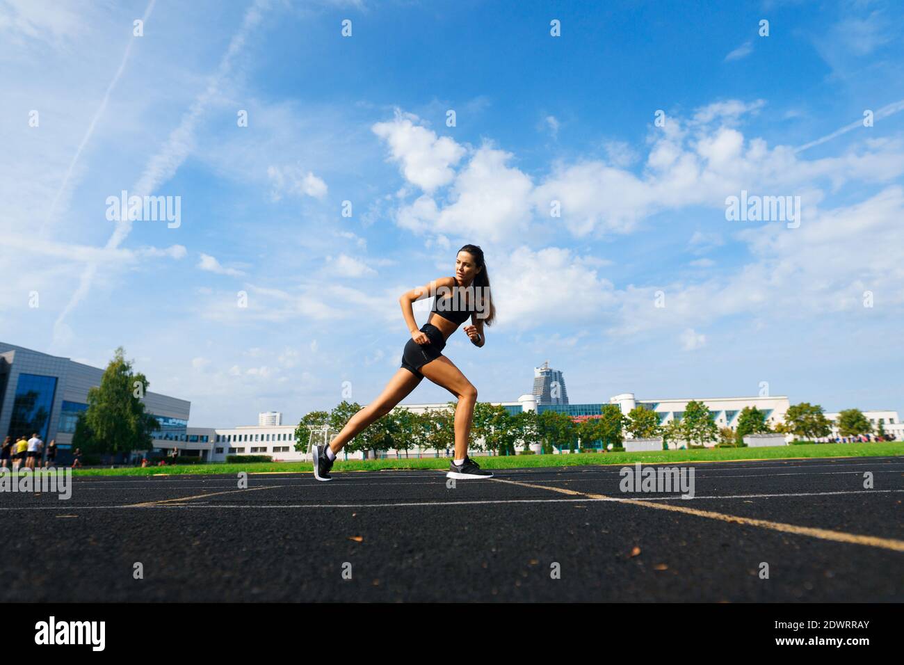 Athlete runner running on athletic track training her cardio. Woman ...