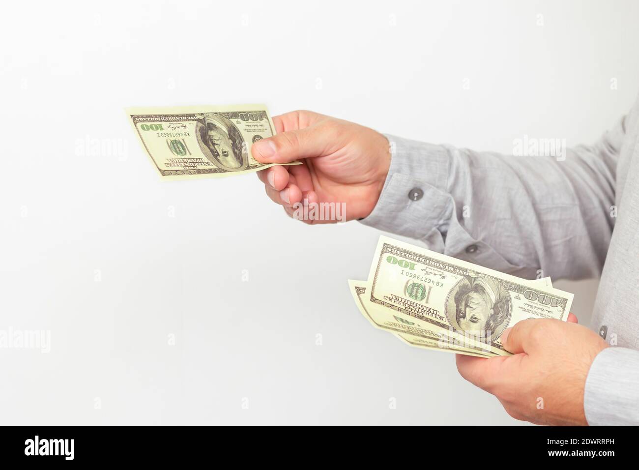 Businessman giving money us dollar bills close-up Stock Photo - Alamy