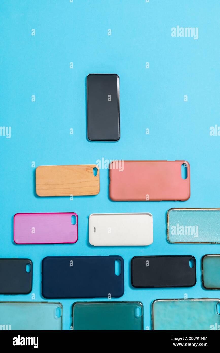Pile of multicolored plastic back covers for mobile phones on blue ...