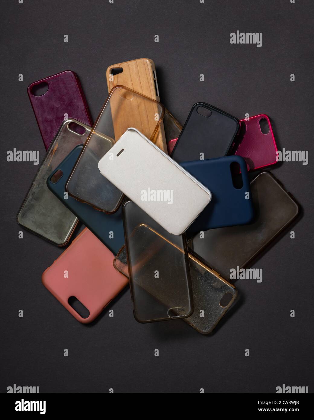 Pile of multicolored plastic back covers for mobile phones on black ...