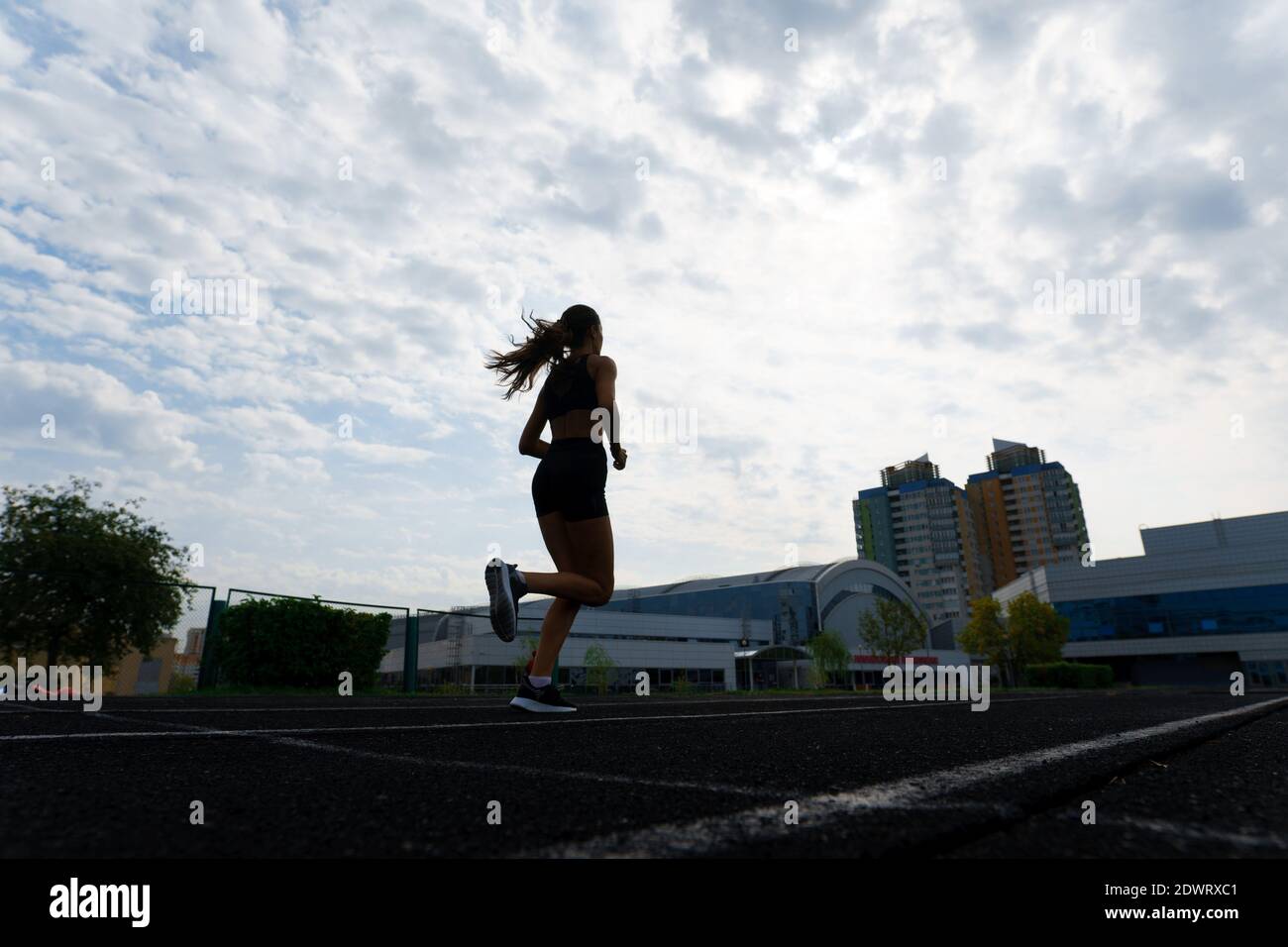 Athlete runner running on athletic track training her cardio. Woman ...