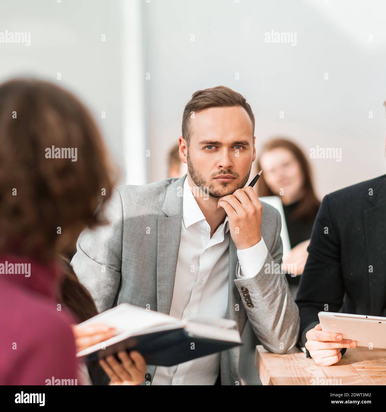 close up. brooding young entrepreneur sitting at office Desk Stock ...