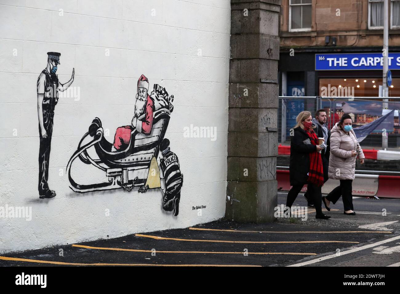 People walk passed new artwork created by street artist The Rebel Bear ...