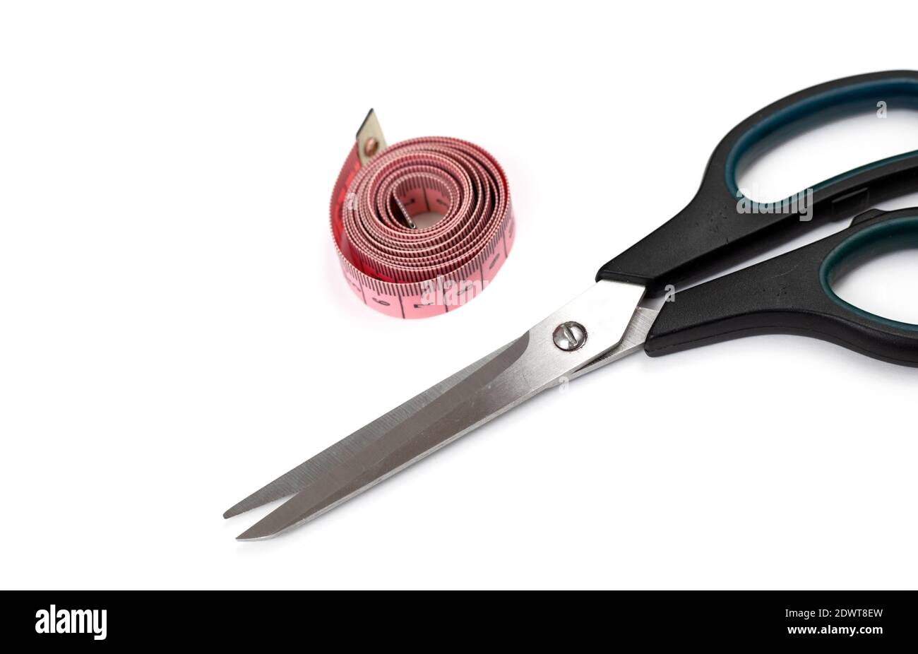 Scissors and pink tape measure on a white background Stock Photo - Alamy