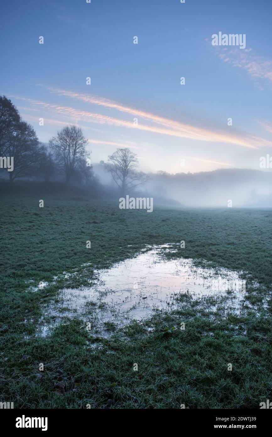 Frozen flood water puddle alongside the river Wye at Brockweir Stock ...