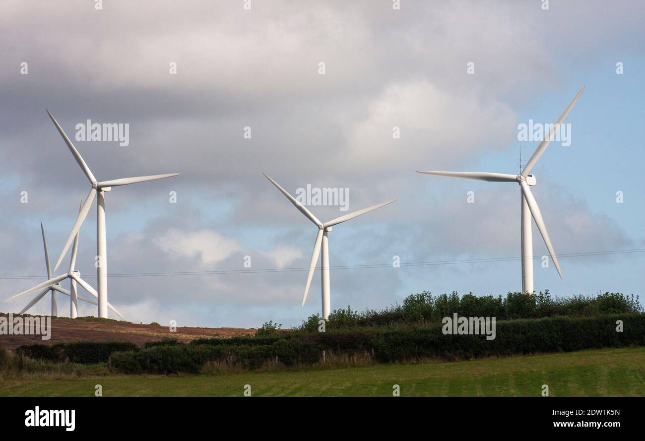 Wind farm Northern Ireland, white wind turbines and blades lit up by ...