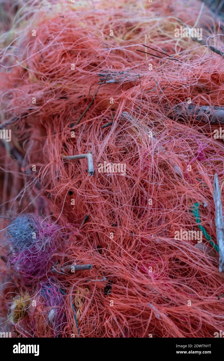 fishing nets washed up by the sea and a piece of rope entangled all ...