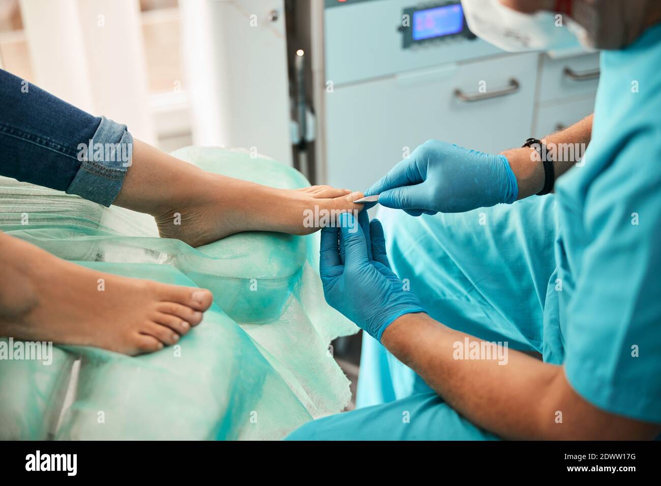 Beautiful woman visiting podiatrist and receiving professional ...