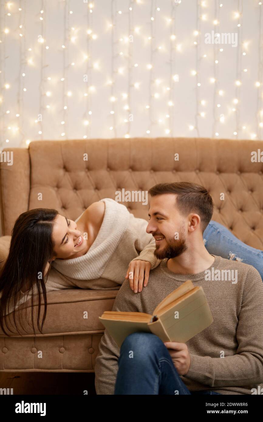 Beautiful young loving couple bonding to each other and smiling while ...