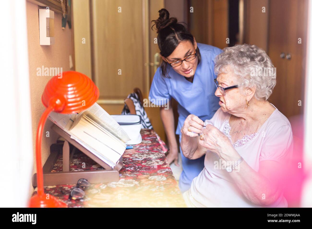 Angry Senior woman with her caregiver at home. Senior home care concept ...