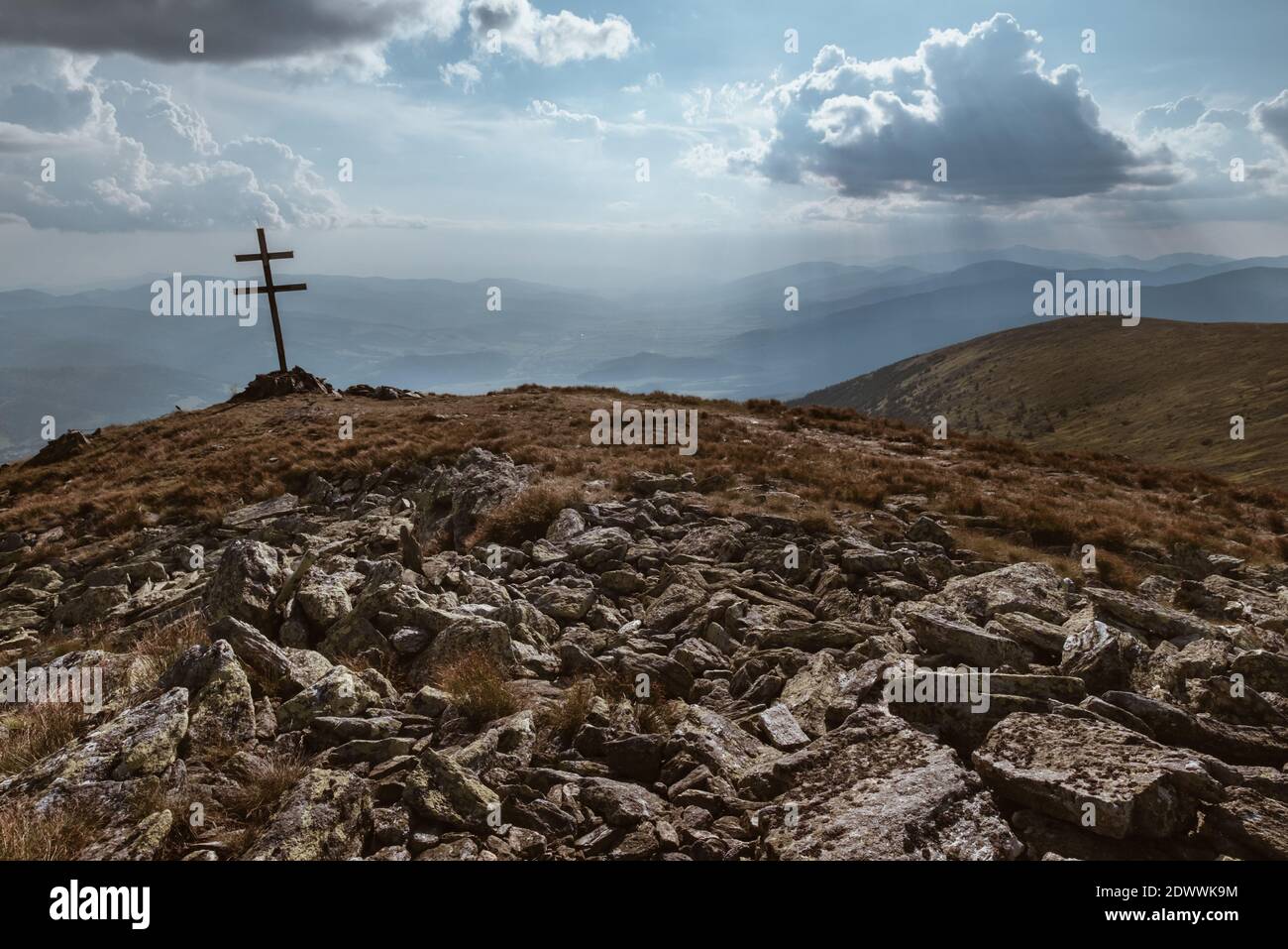 Patriarchal cross on the mountain summit with spectacular sun rays ...