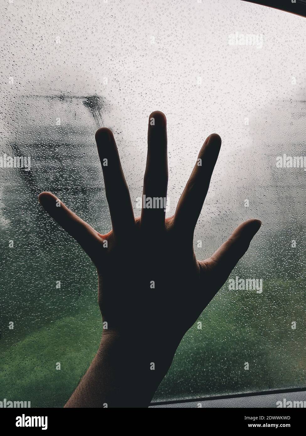 Hand against window rain hi-res stock photography and images - Alamy