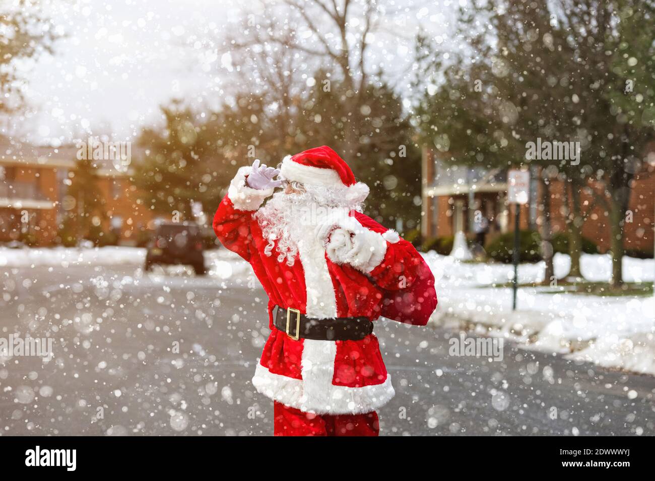 Snow landscape Santa Claus carrying a heavy bag to children walking ...