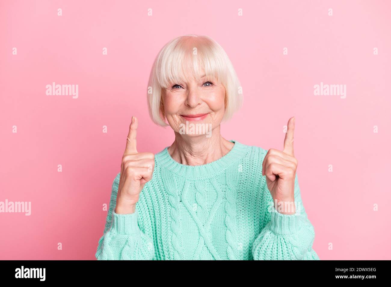 Photo portrait of pretty old lady pointing up at blank space smiling ...
