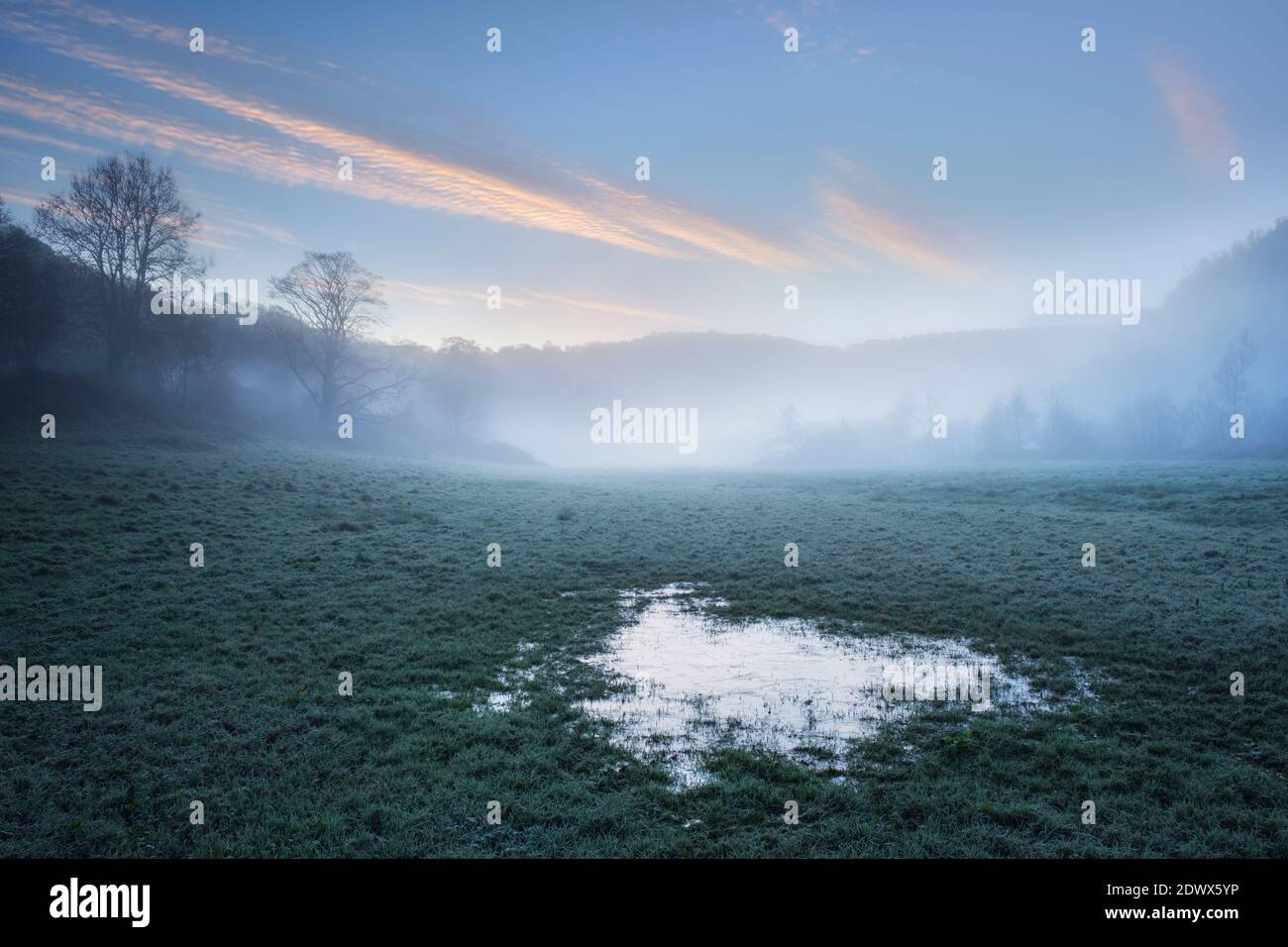 Frozen flood water puddle alongside the river Wye at Brockweir Stock ...