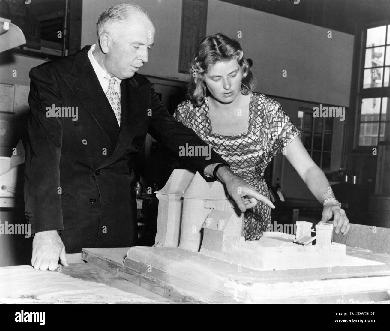Art Director RICHARD DAY shows set model to INGRID BERGMAN candid ...