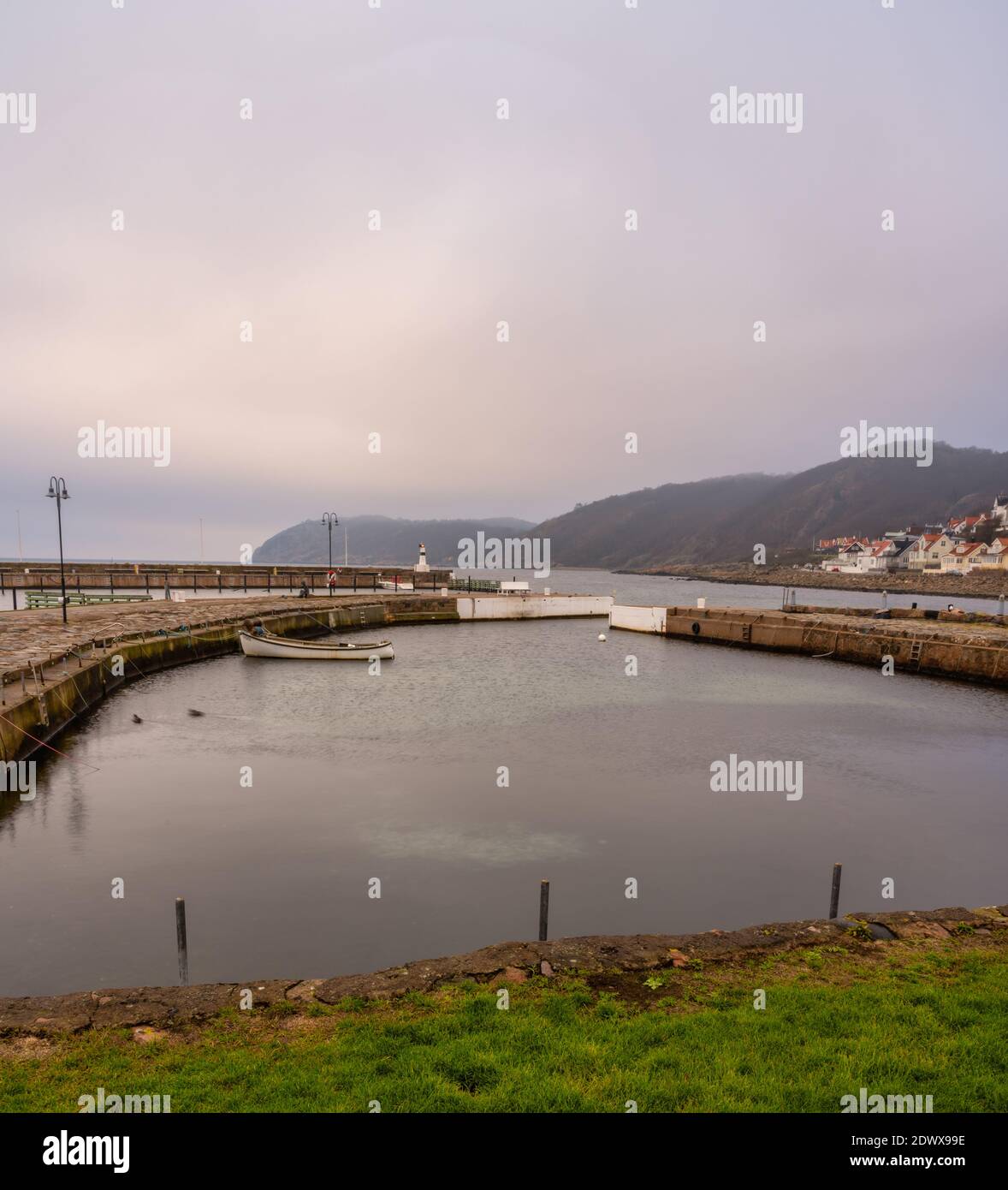 An empty marina in the winter. Mountains in fog in the background ...