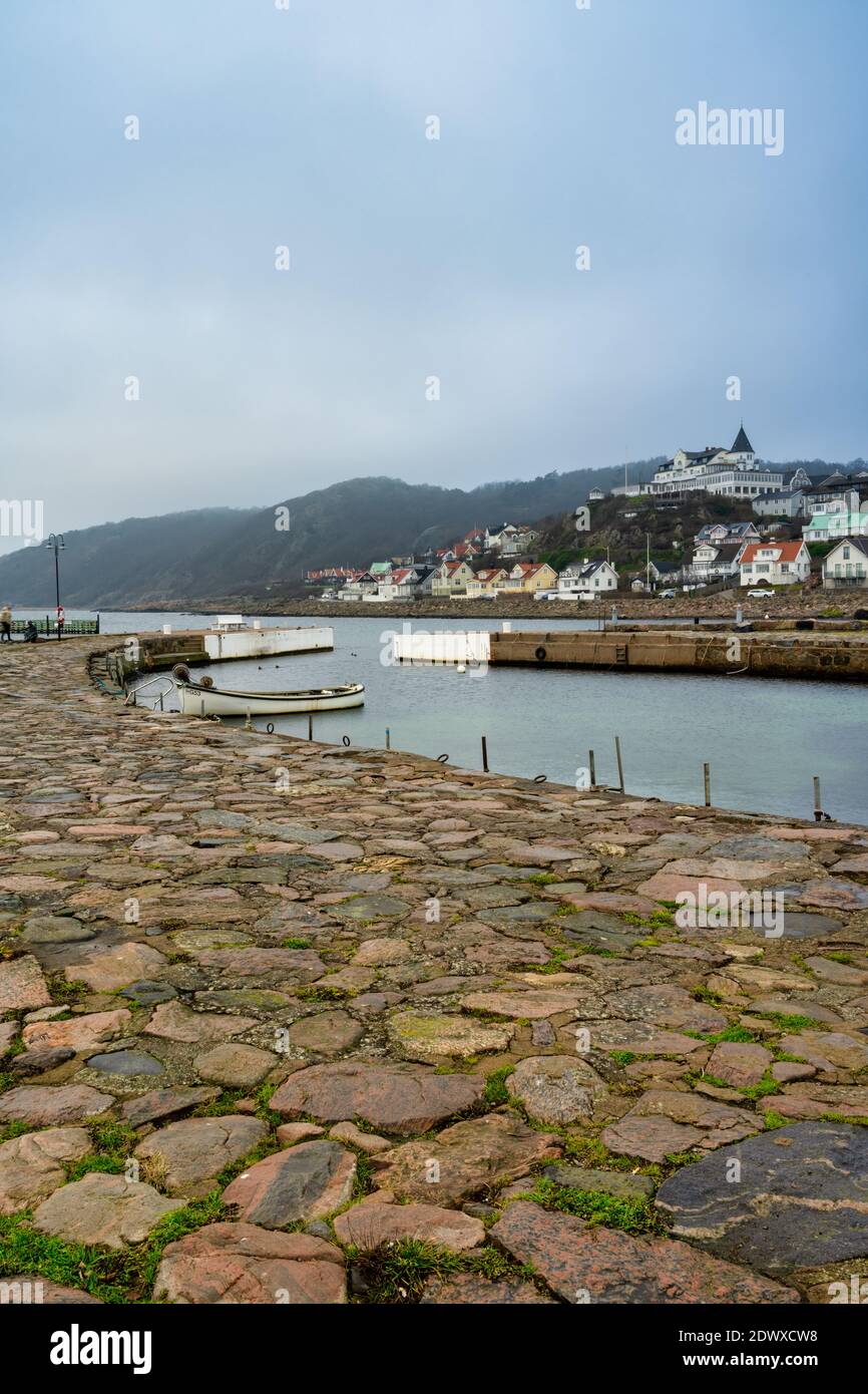 An empty marina in the winter. Mountains in fog in the background ...