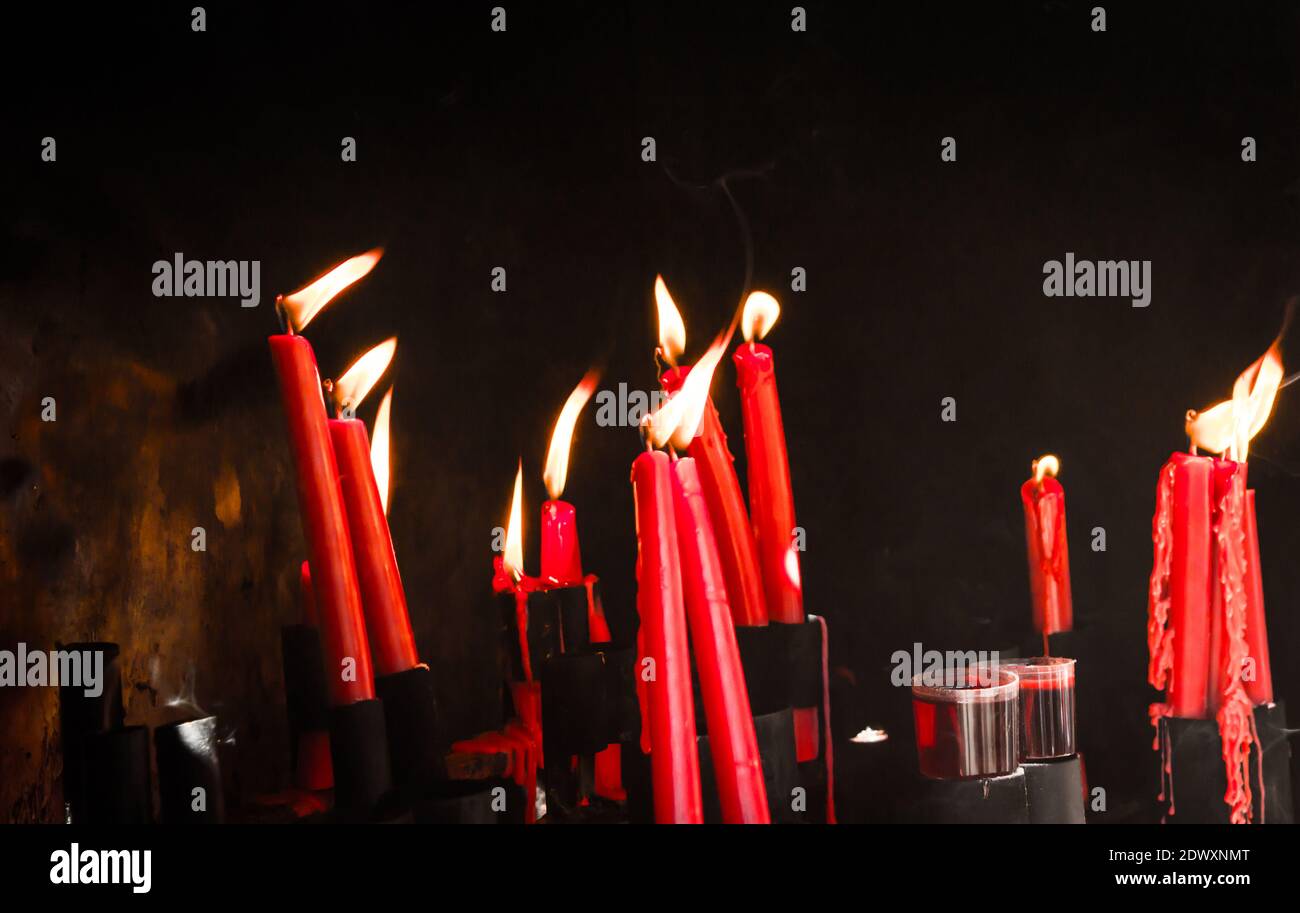Red Lit Candles In Room Stock Photo - Alamy