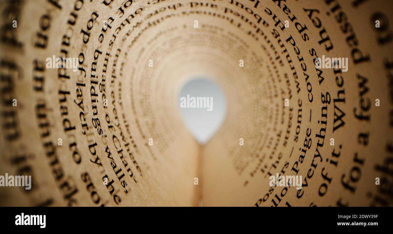 inside the rolled up sheet of paper with text from book Stock Photo - Alamy
