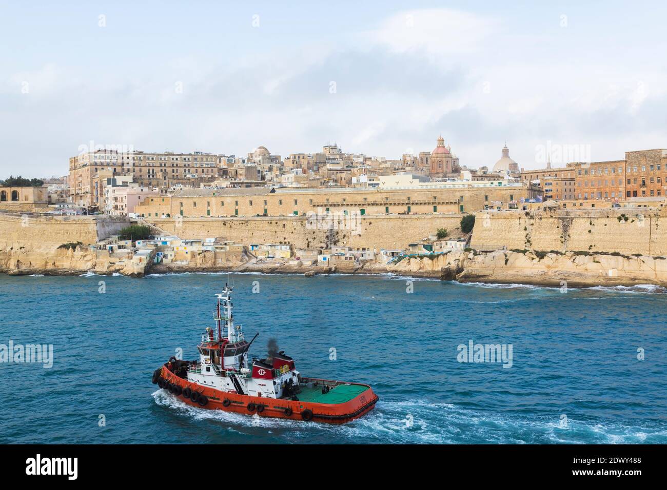 Red Lieni tugboat and Valletta city skyline with old fortification ...